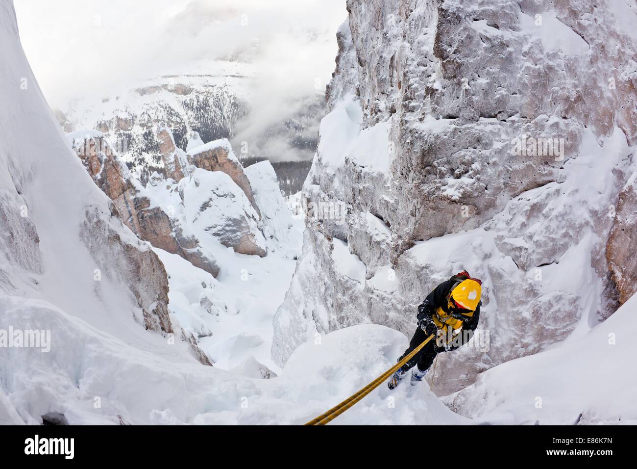 Climber abseiling back down using a double rope during an extreme ...