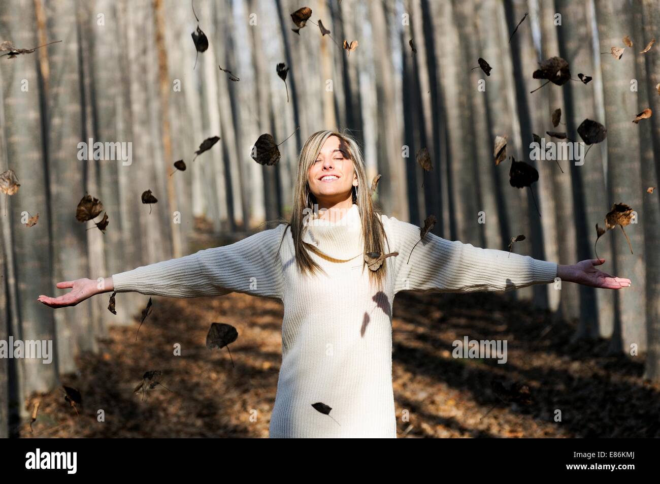 Beautiful blonde girl with falling leaves in the autumn park Stock ...