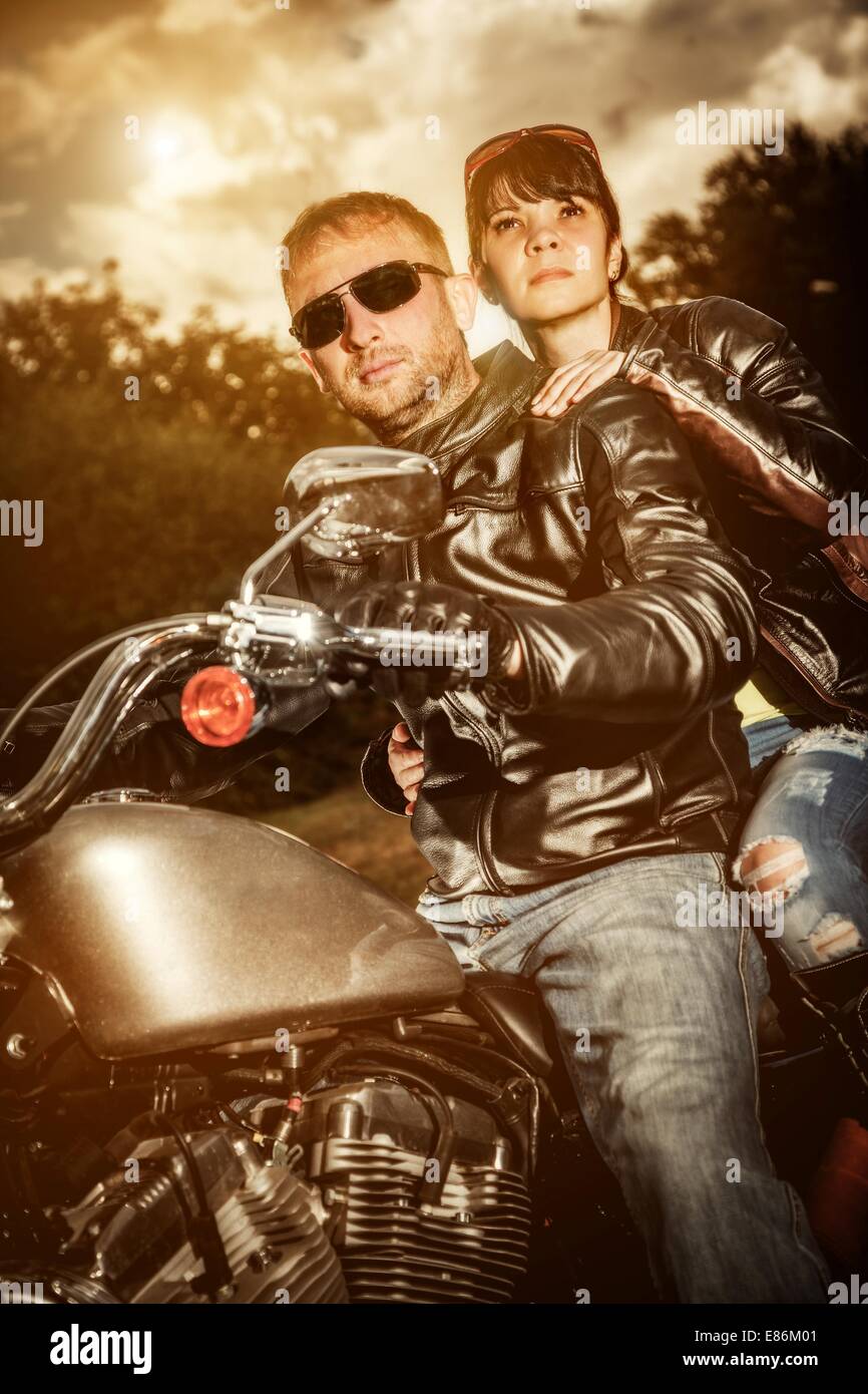 Biker couple, man and woman in leather jacket on a motorcycle Stock ...