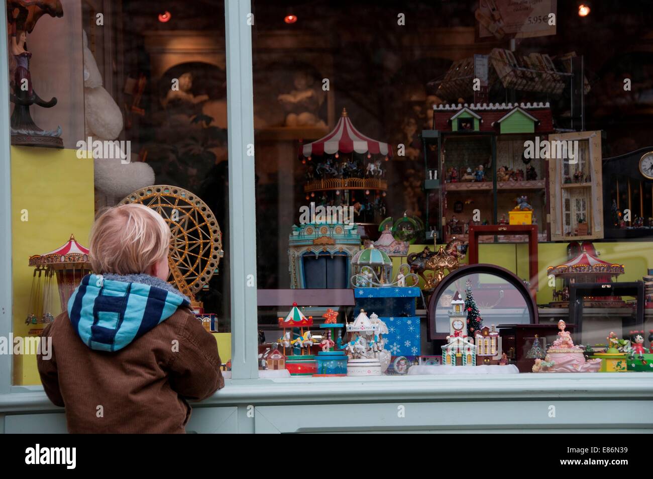 A boy looking in a shop window Stock Photo - Alamy