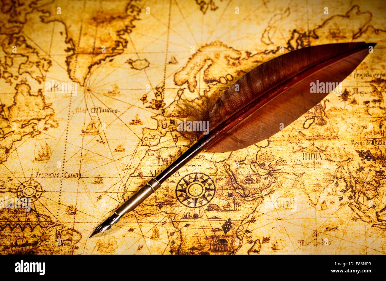 Vintage still life. Vintage goose quill pen lying on an old map Stock ...