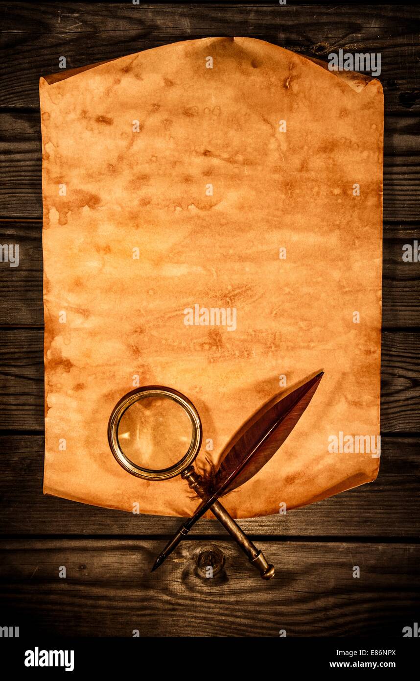 Blank old paper with curled edge against the background of an aged wood ...
