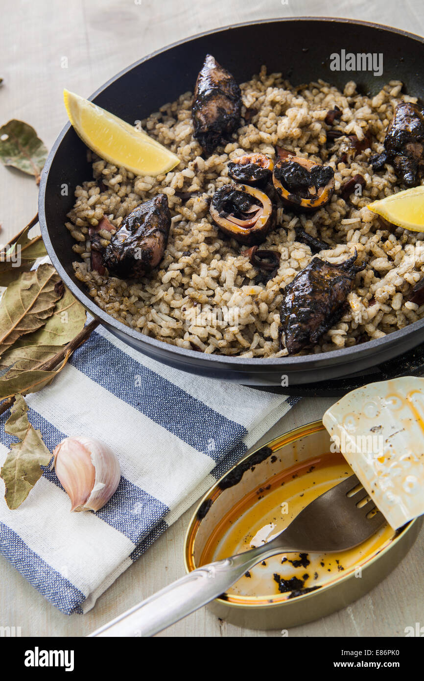 rice with squid on ink sauce on pan Stock Photo - Alamy