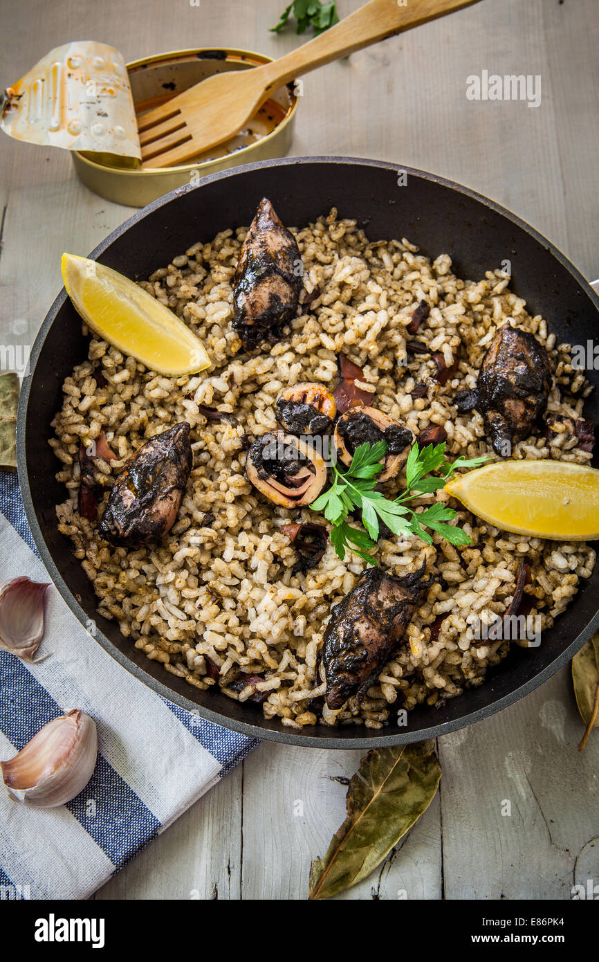 rice with squid on ink sauce on pan Stock Photo - Alamy