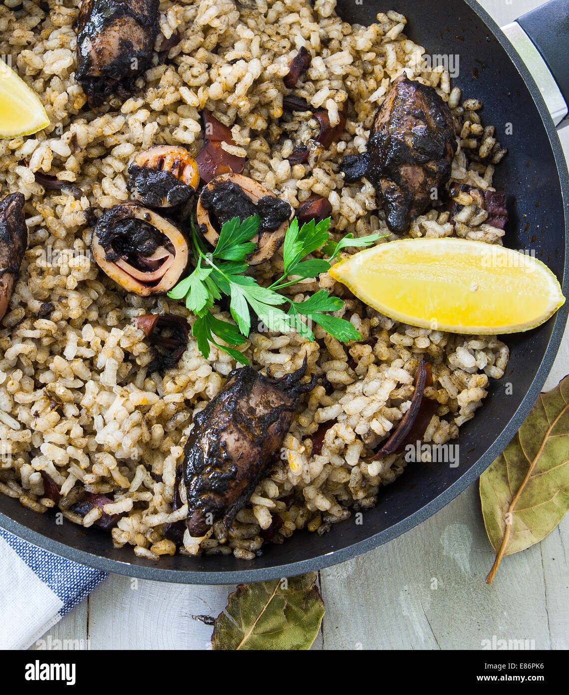 rice with squid on ink sauce on pan Stock Photo - Alamy
