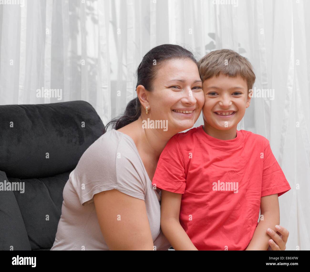 Happy mom and son hugging laughing Stock Photo - Alamy