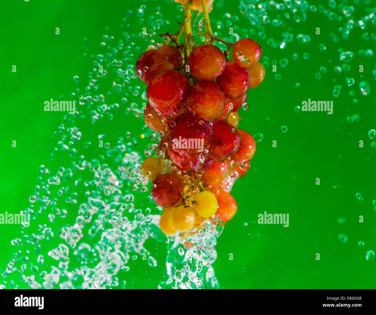 Red grape with water with splash isolated on green background Stock ...