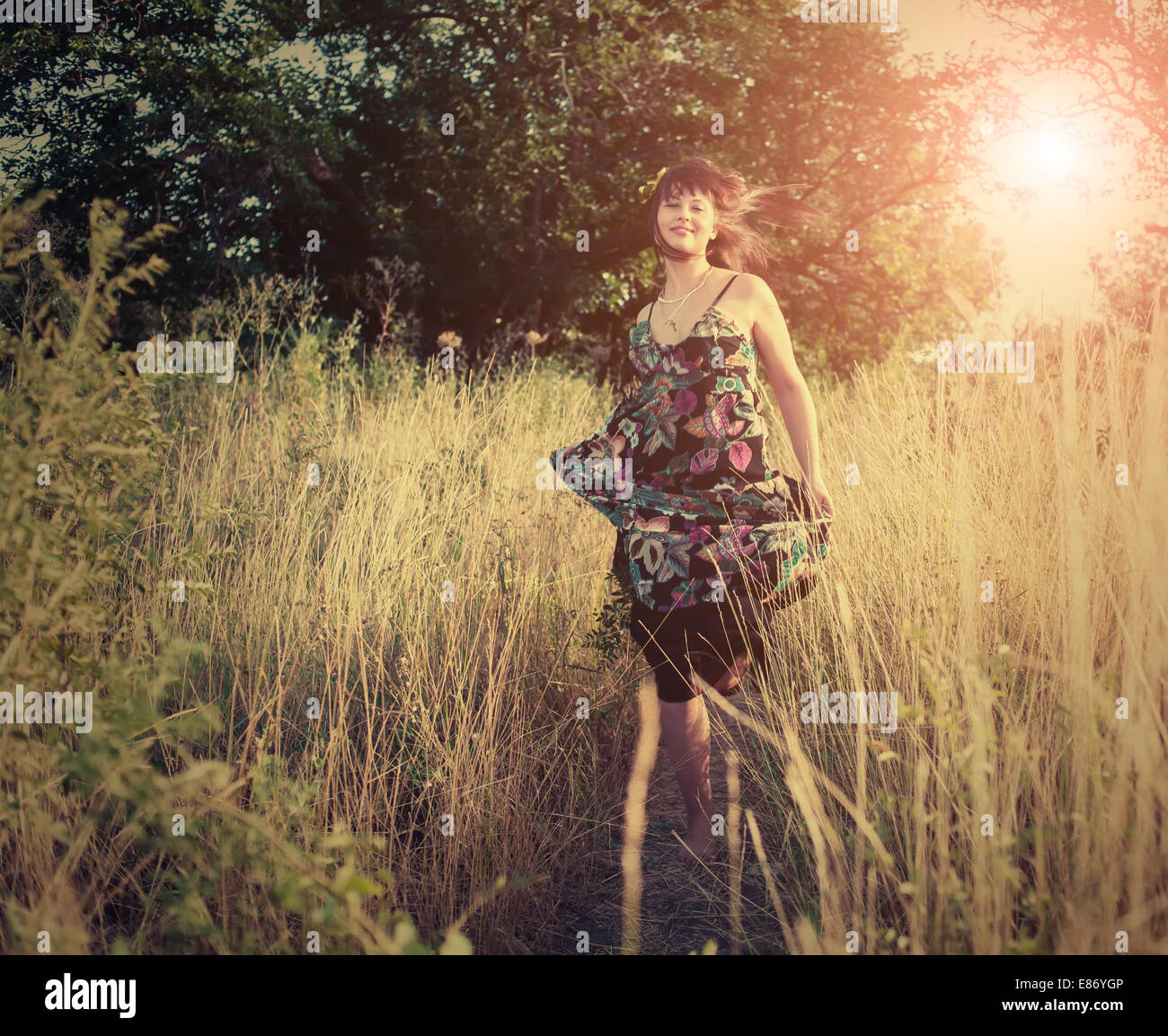 Women dancing in a high grass and smiling Stock Photo - Alamy