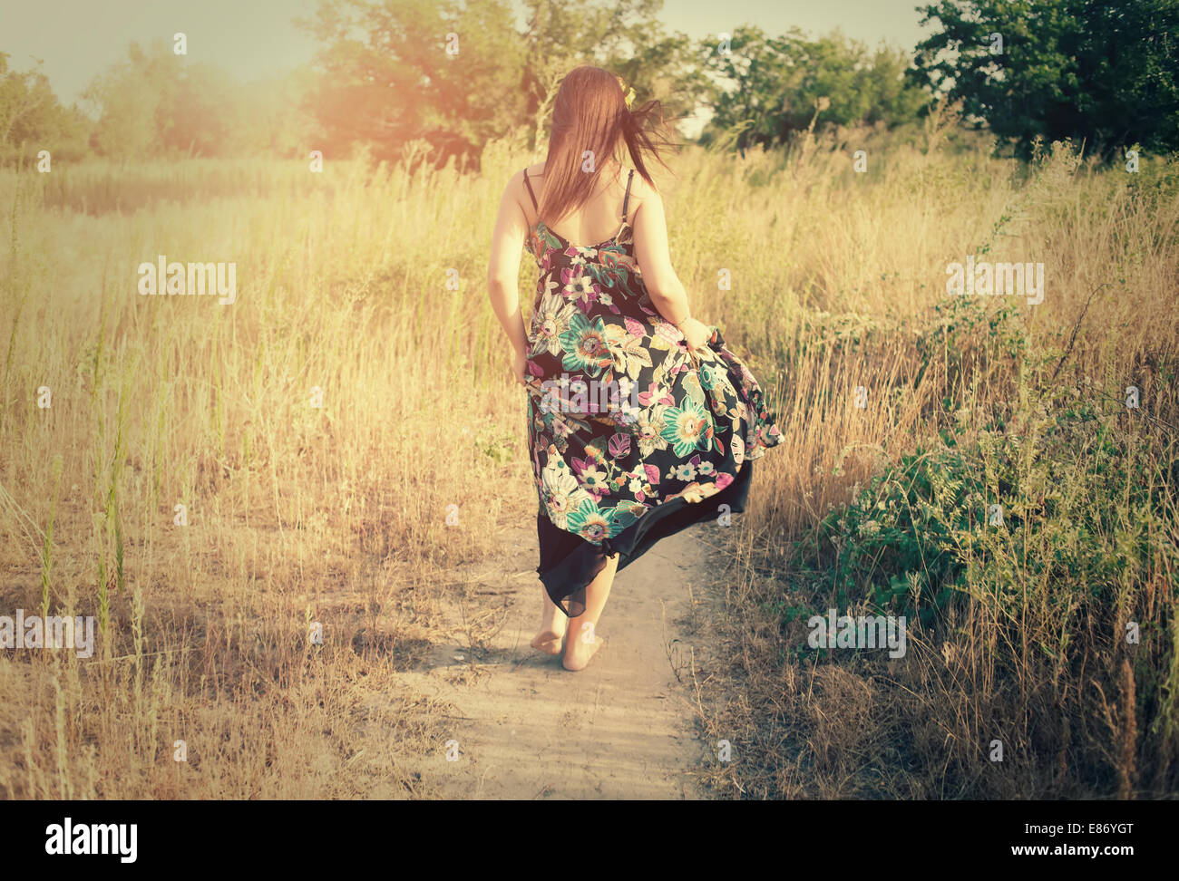 Woman running rear view park dress hi-res stock photography and images ...