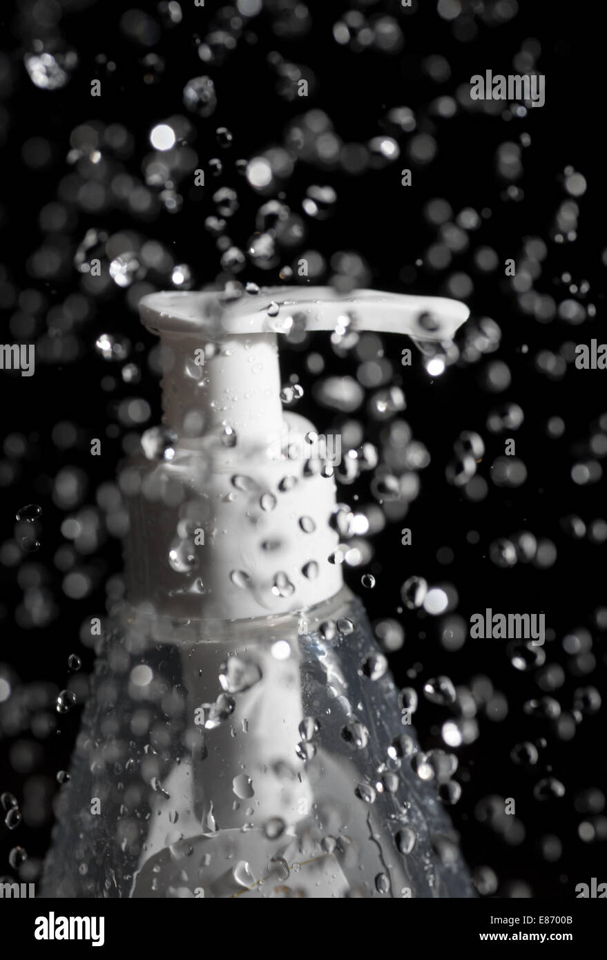 white spa cosmetics tube under water drops flow Stock Photo - Alamy