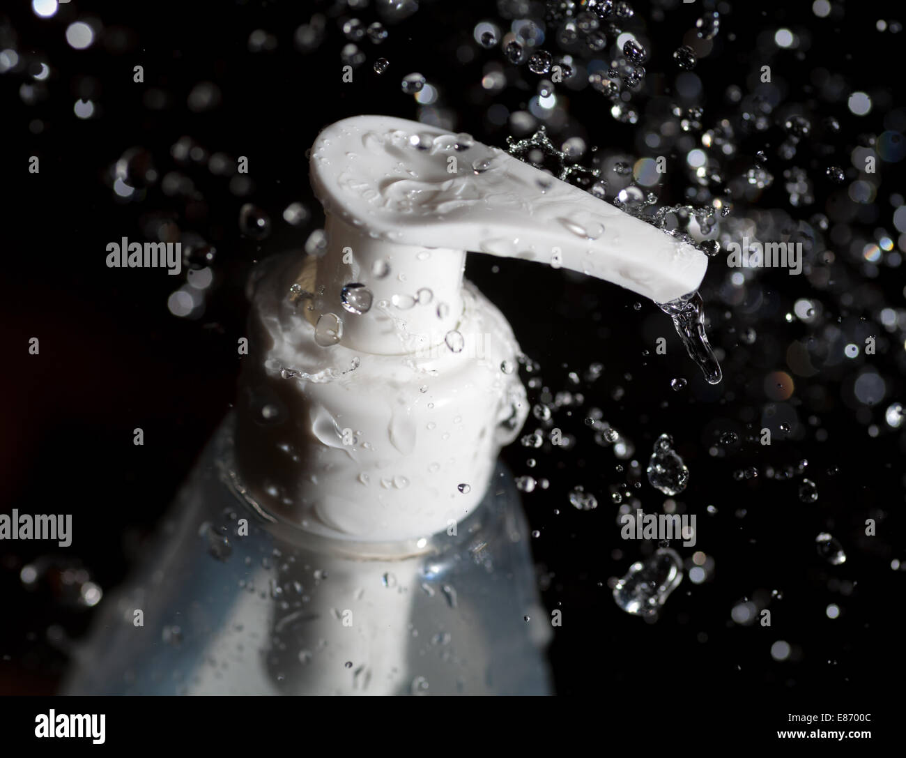 cosmetics tube under water drops flying in the air Stock Photo - Alamy