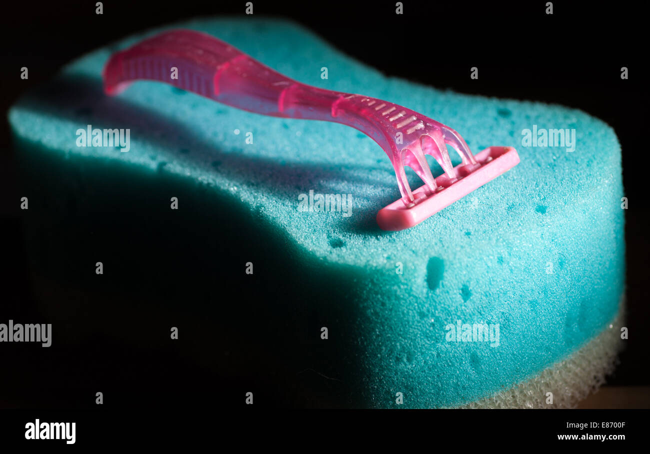 pink women razor blade shaving tool on the blue bath sponge Stock Photo ...