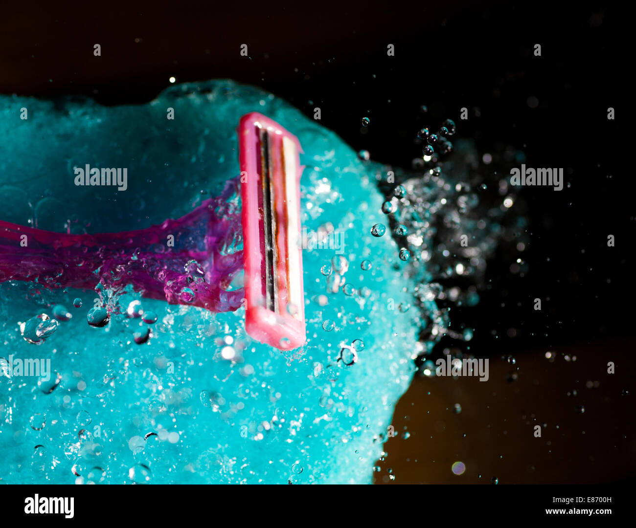 Pink women shaving tool on the blue bath sponge hi-res stock ...