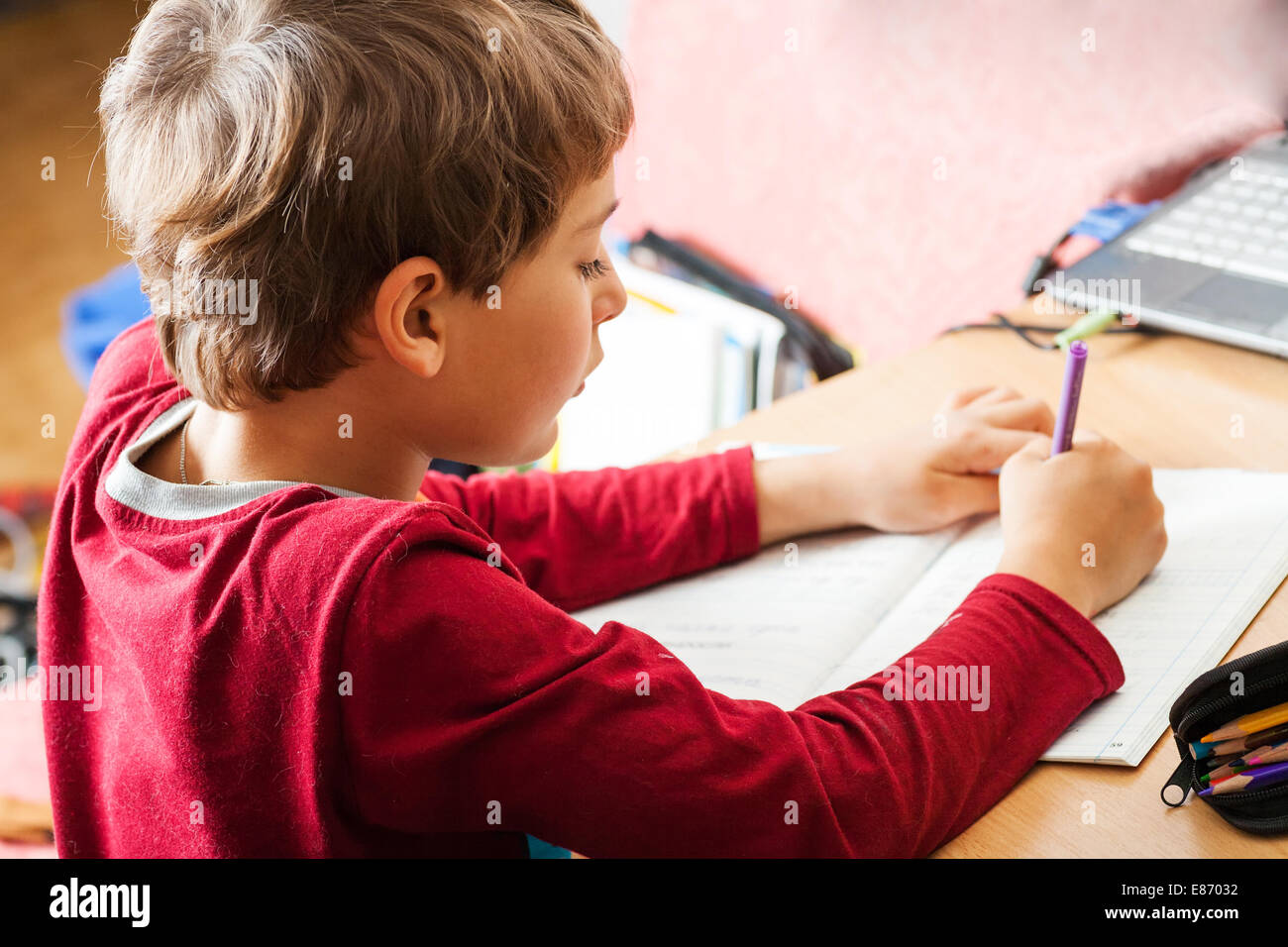 boy writing indoors Stock Photo - Alamy