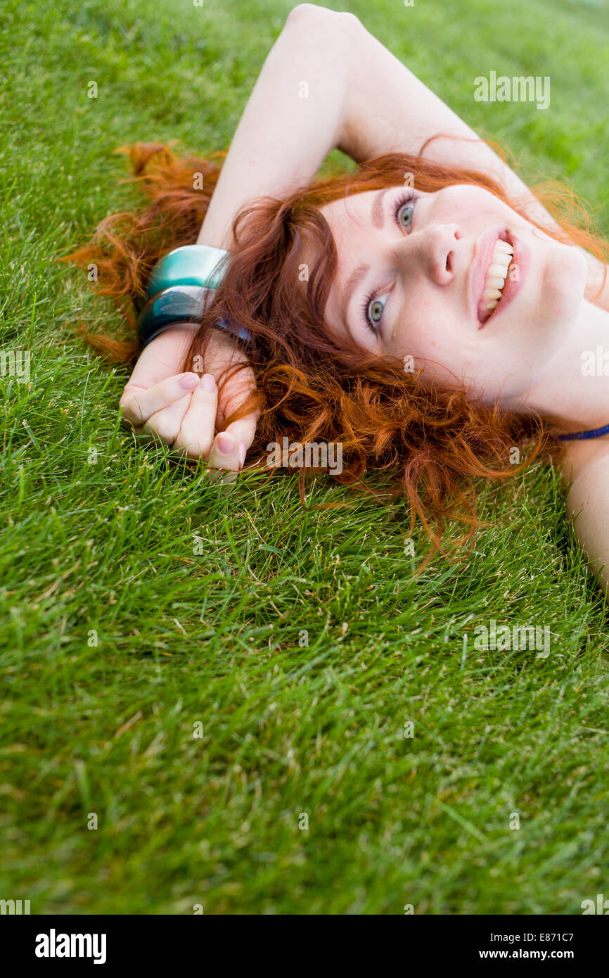 redhead smiling on grass, face closeup Stock Photo - Alamy