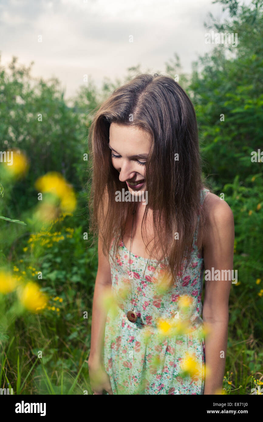 Female looking down and smiling. Beautiful Young Woman standing in ...