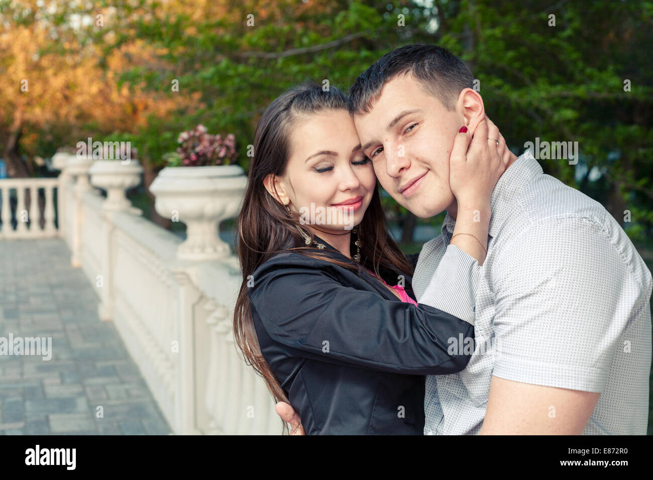 Together and very happy. Cute couple embracing Stock Photo - Alamy