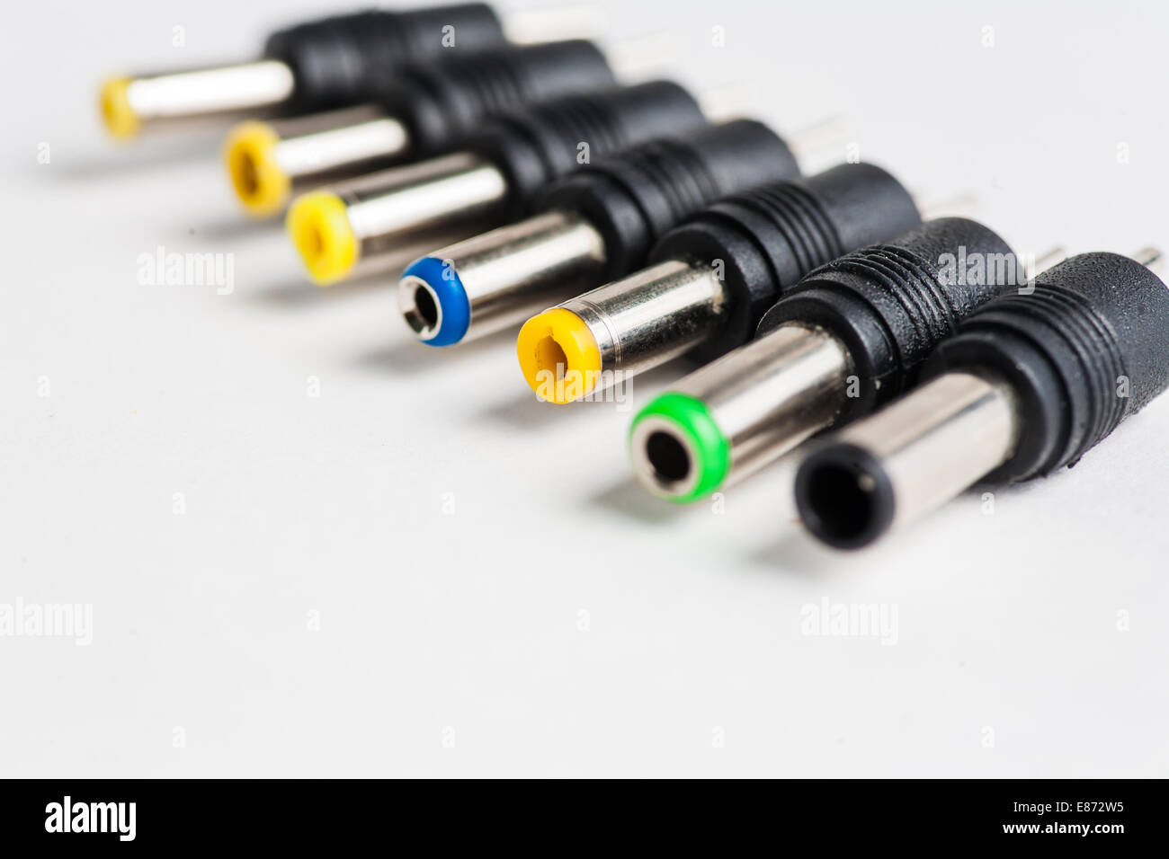 Electric plugs set for laptop on white Stock Photo - Alamy