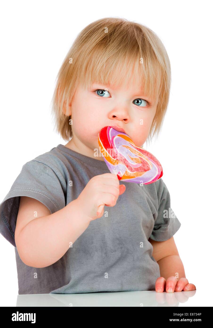 Baby eating a sticky lollipop isolated on white background Stock Photo ...