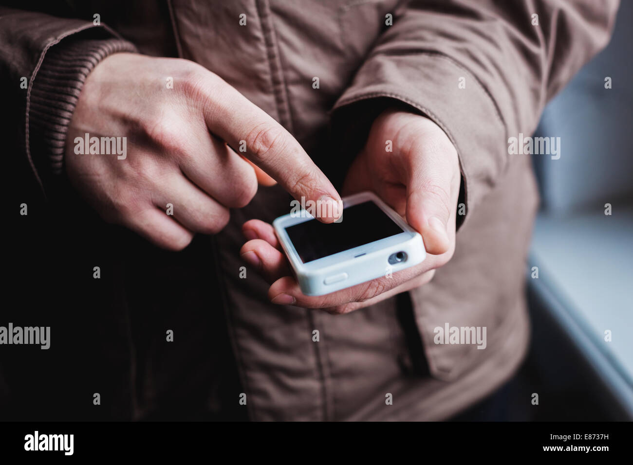 The man is using a smartphone. Modern mobile phone in hand Stock Photo ...