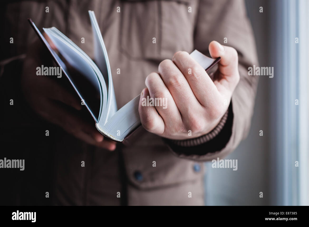 Man reading. Book in his hands Stock Photo - Alamy