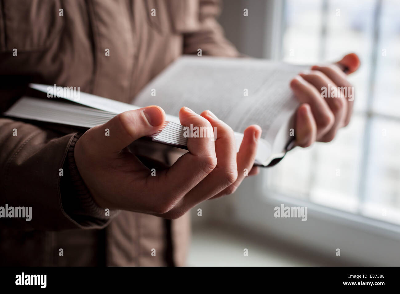 Man reading. Book in his hands Stock Photo - Alamy