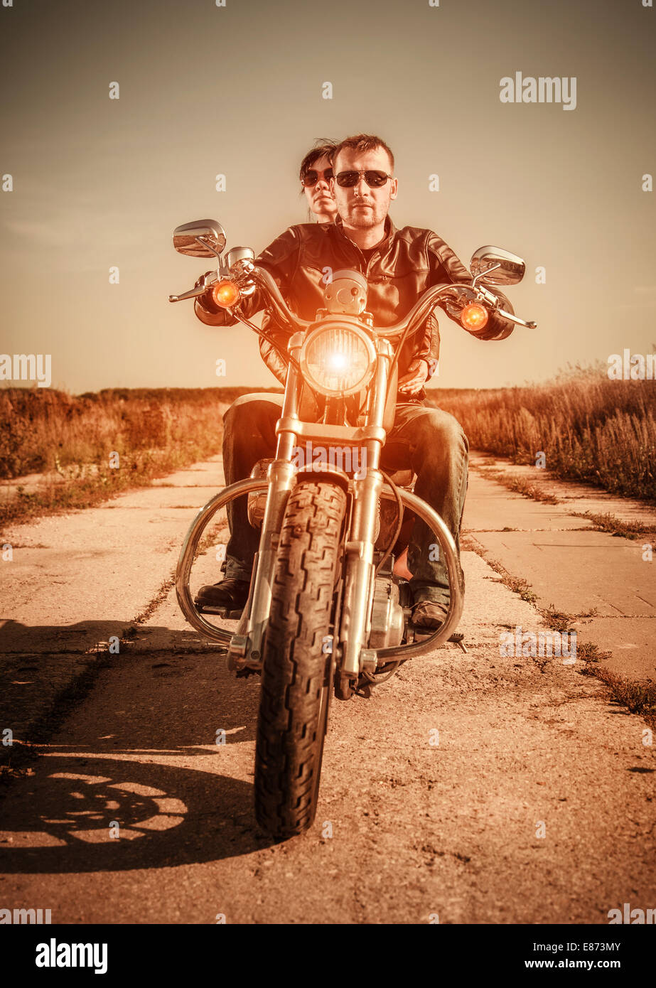 Couple Bikers in a leather jacket riding a motorcycle on the road Stock ...