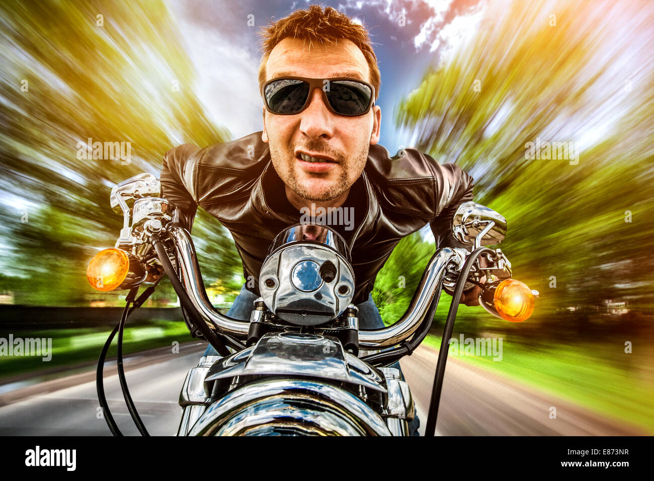 Biker man wearing a leather jacket and sunglasses sitting on his ...