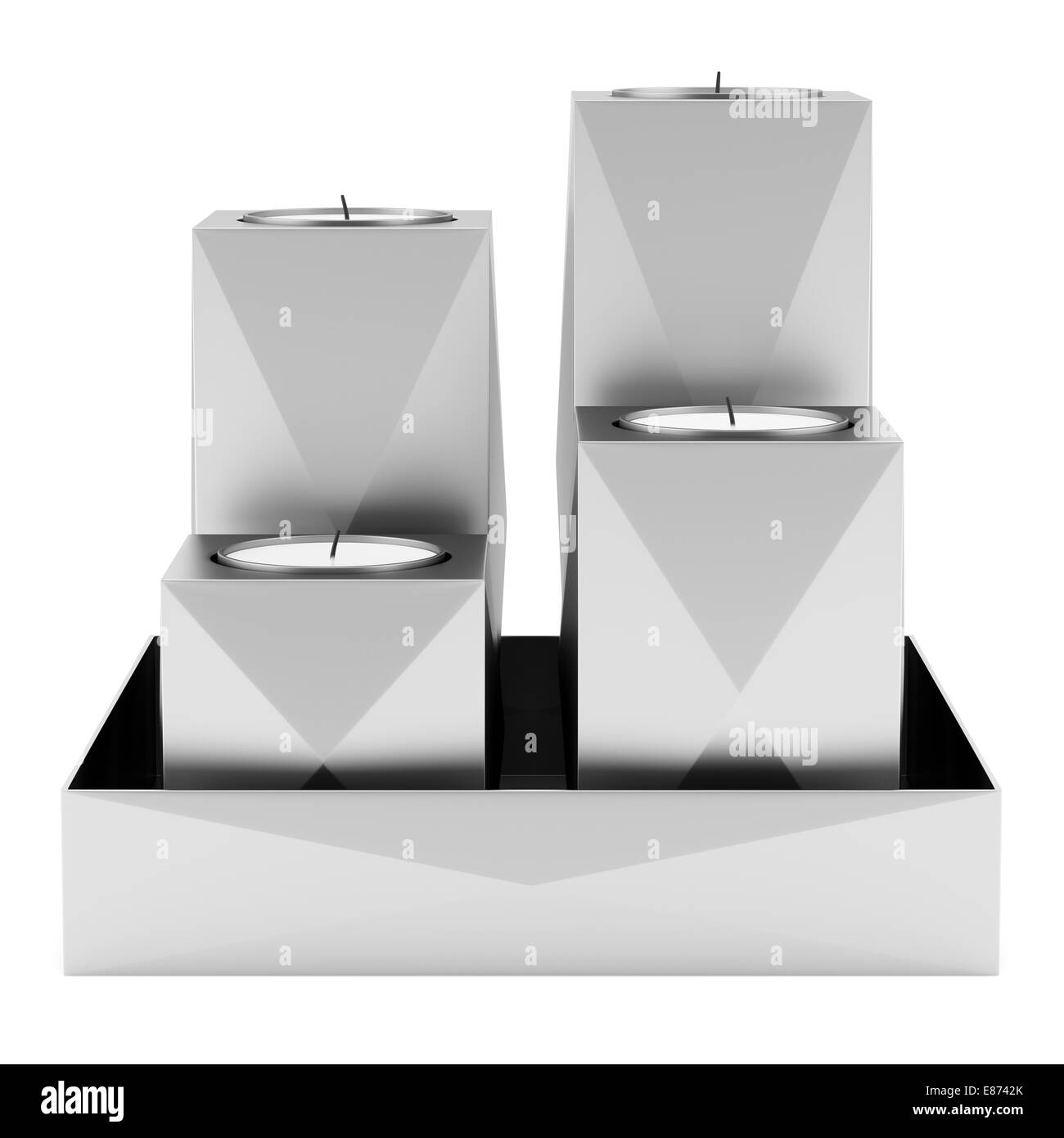 four metallic candlesticks with candles isolated on white background ...