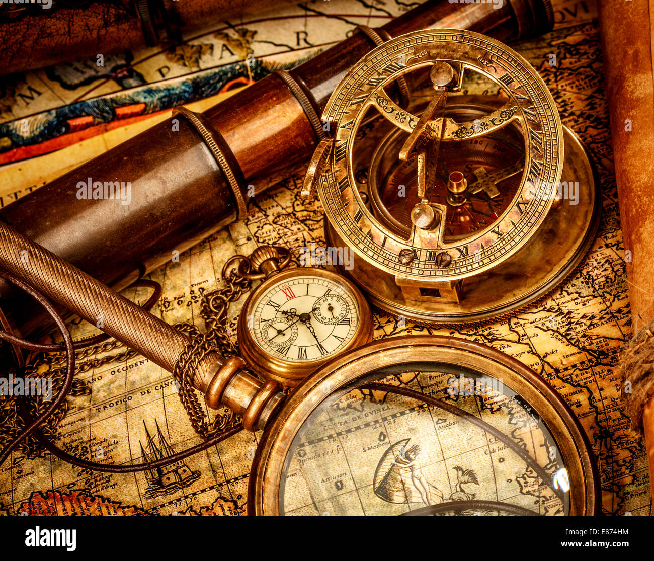 Vintage magnifying glass, compass, telescope and a pocket watch lying ...