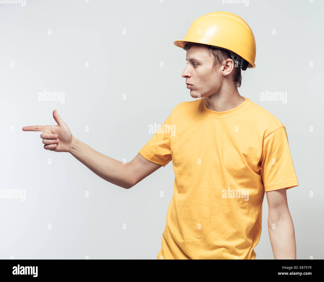 Worker in yellow helmet Stock Photo - Alamy