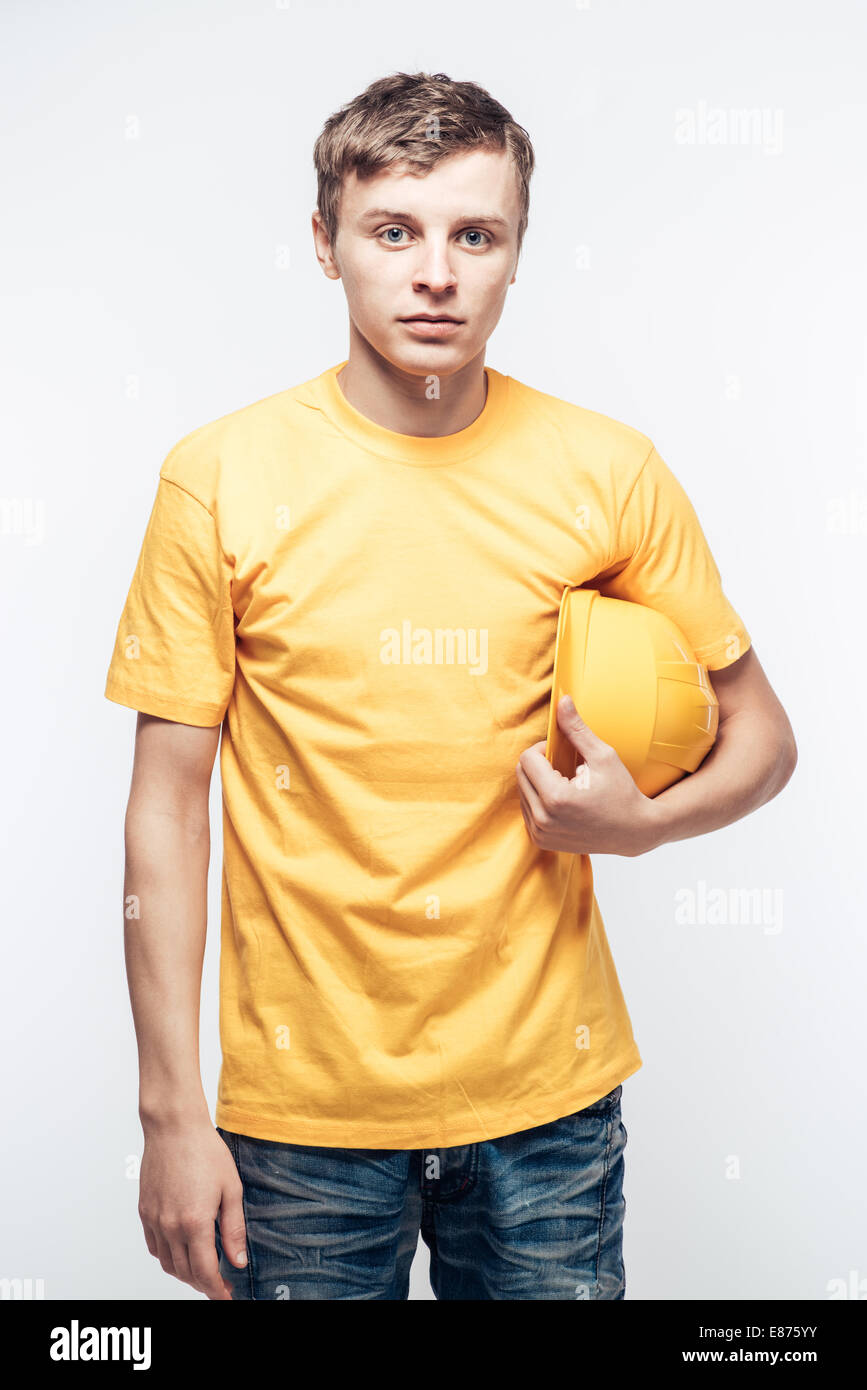 Male worker holding yellow helmet Stock Photo - Alamy