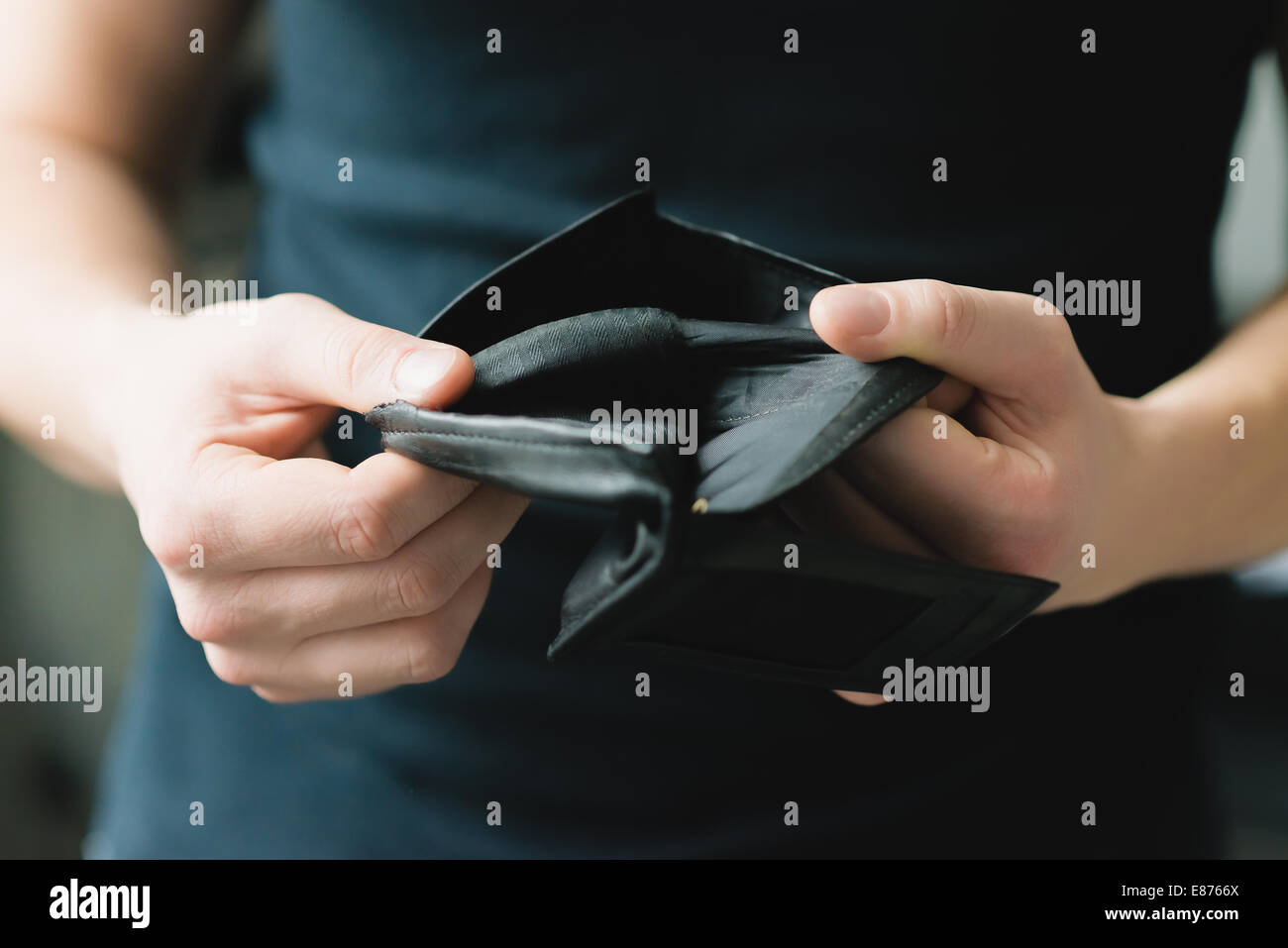 Man holding an empty wallet Stock Photo - Alamy