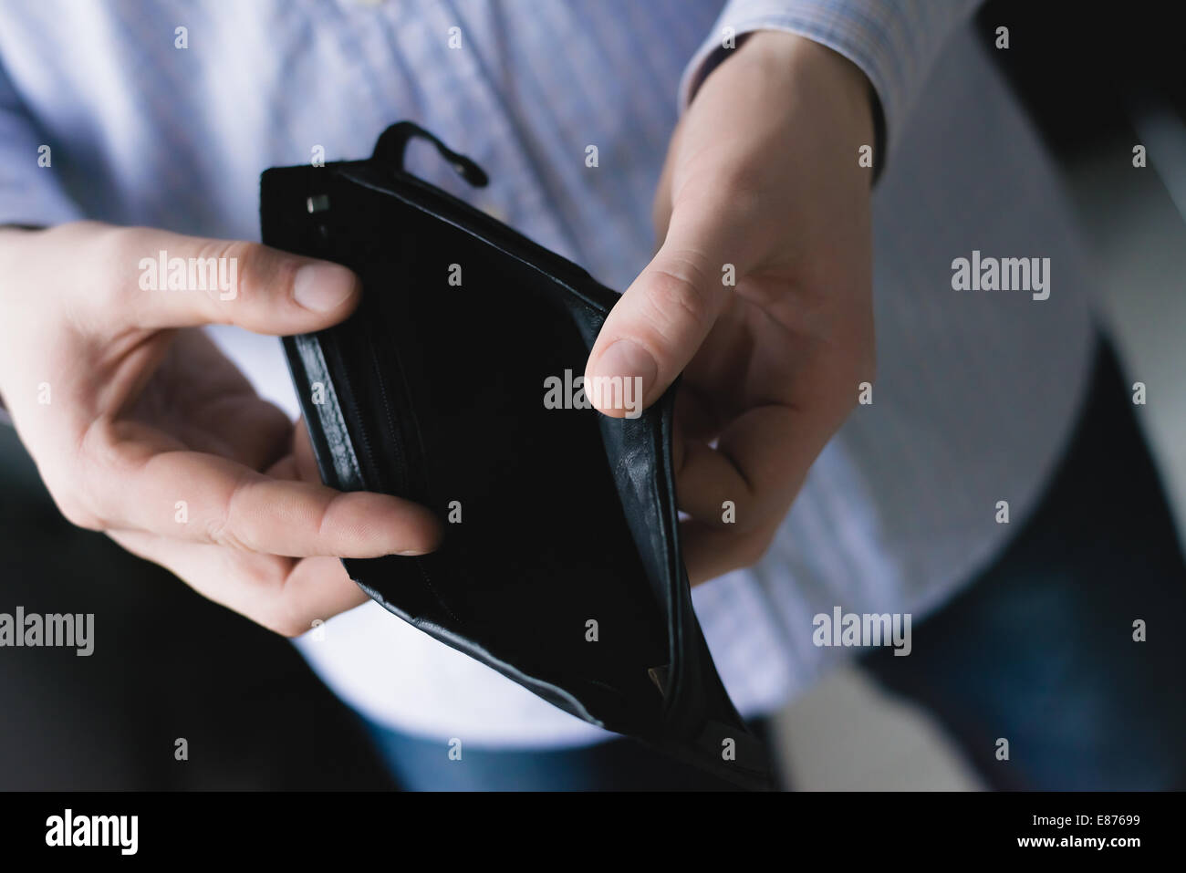 Man holding an empty wallet Stock Photo - Alamy