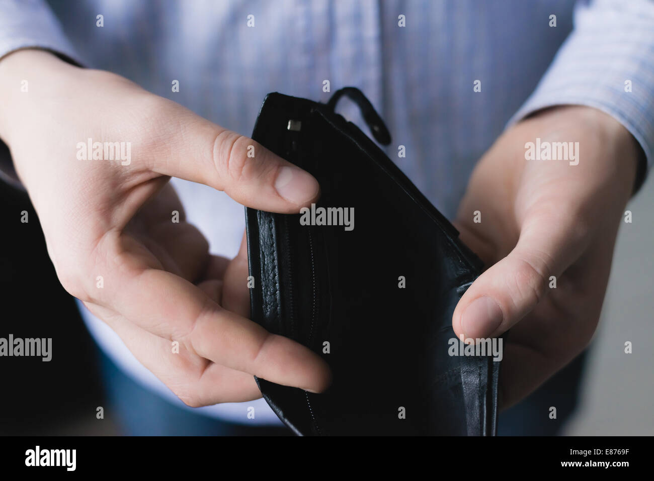 Man holding an empty wallet Stock Photo - Alamy