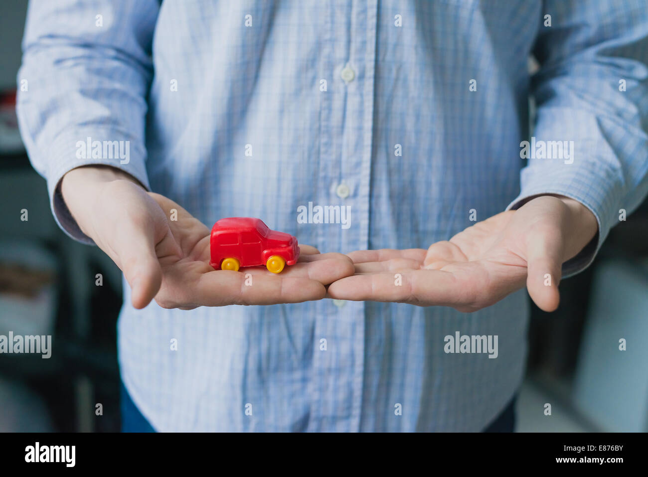 Man holds in his hand cars Stock Photo - Alamy