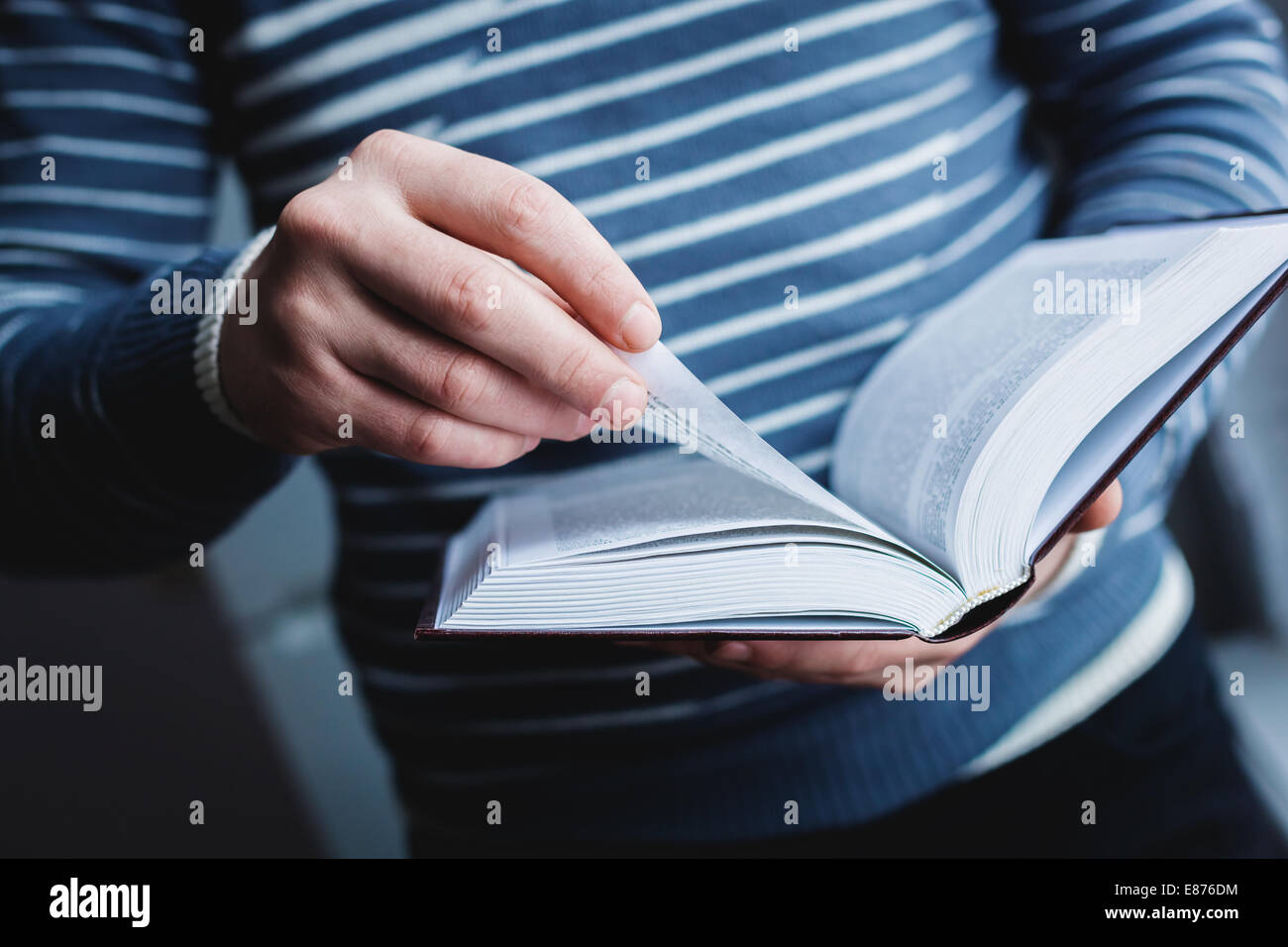 Man reading. Book in his hands Stock Photo - Alamy