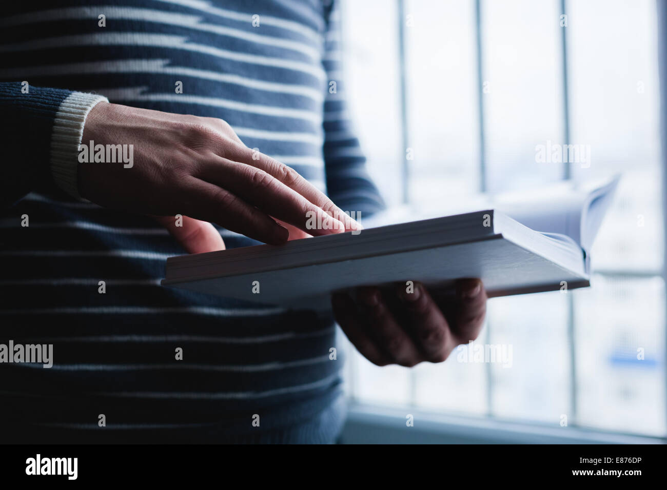 Man reading. Book in his hands Stock Photo - Alamy