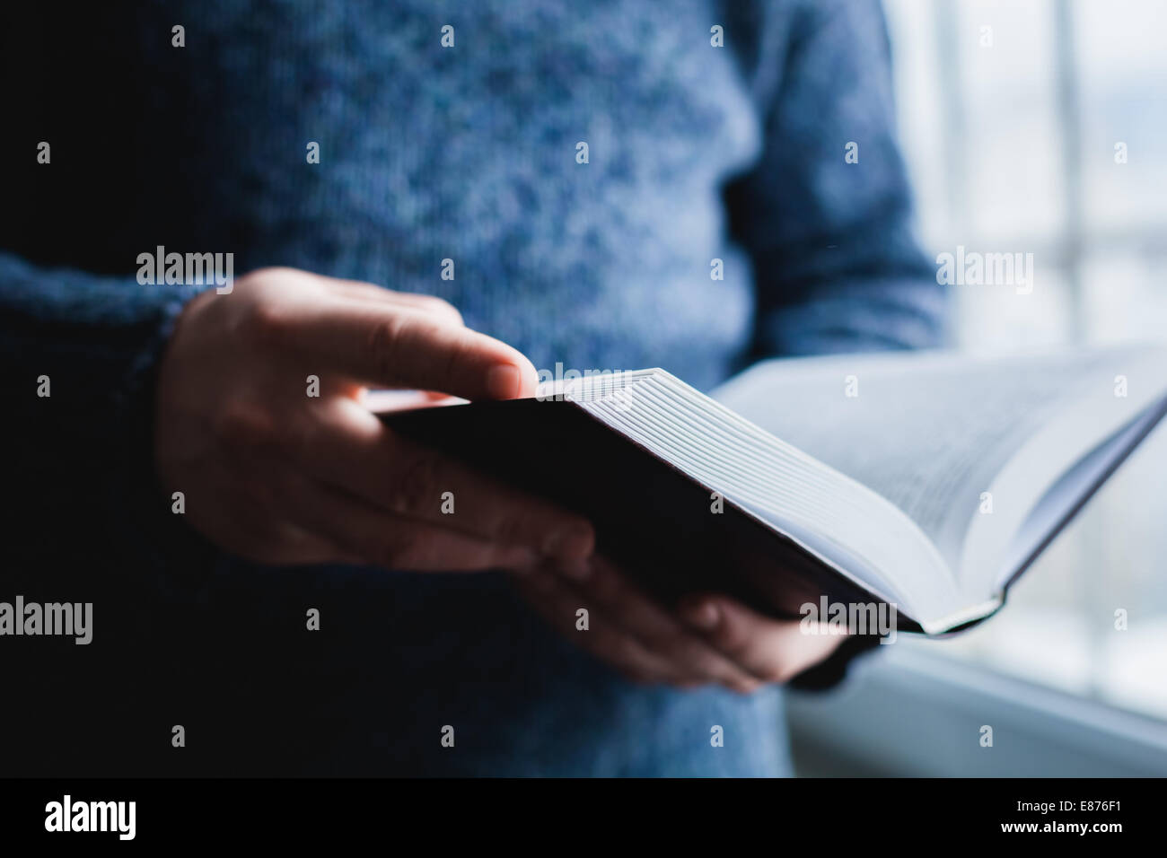 Man reading. Book in his hands Stock Photo - Alamy