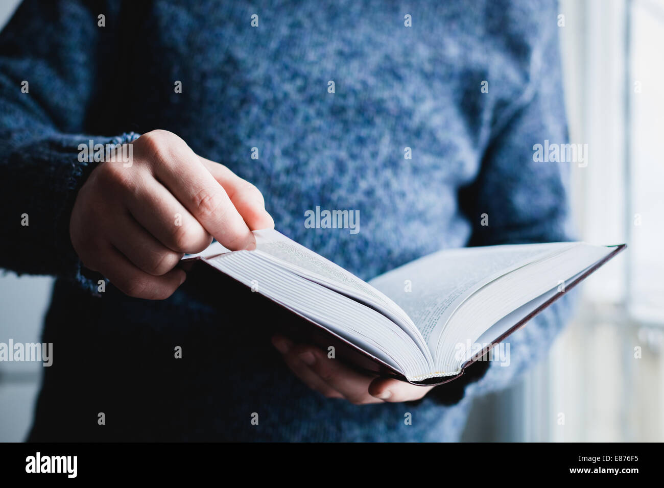 Man reading. Book in his hands Stock Photo - Alamy