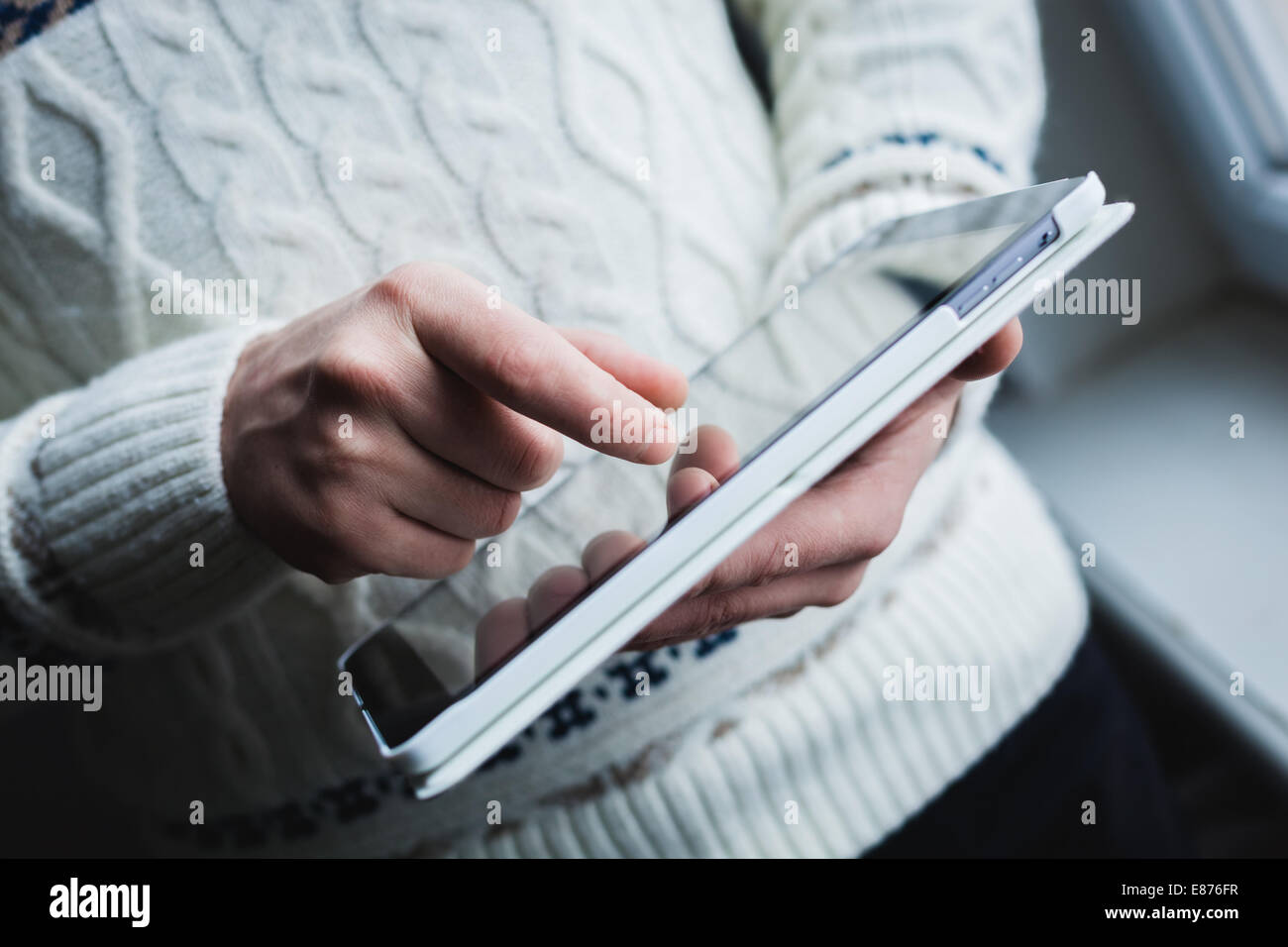 The man uses a tablet PC. Modern gadget in hand Stock Photo - Alamy