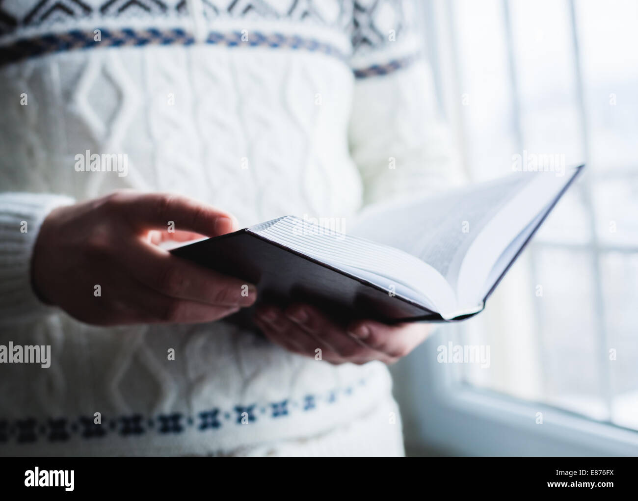 Man reading. Book in his hands Stock Photo - Alamy