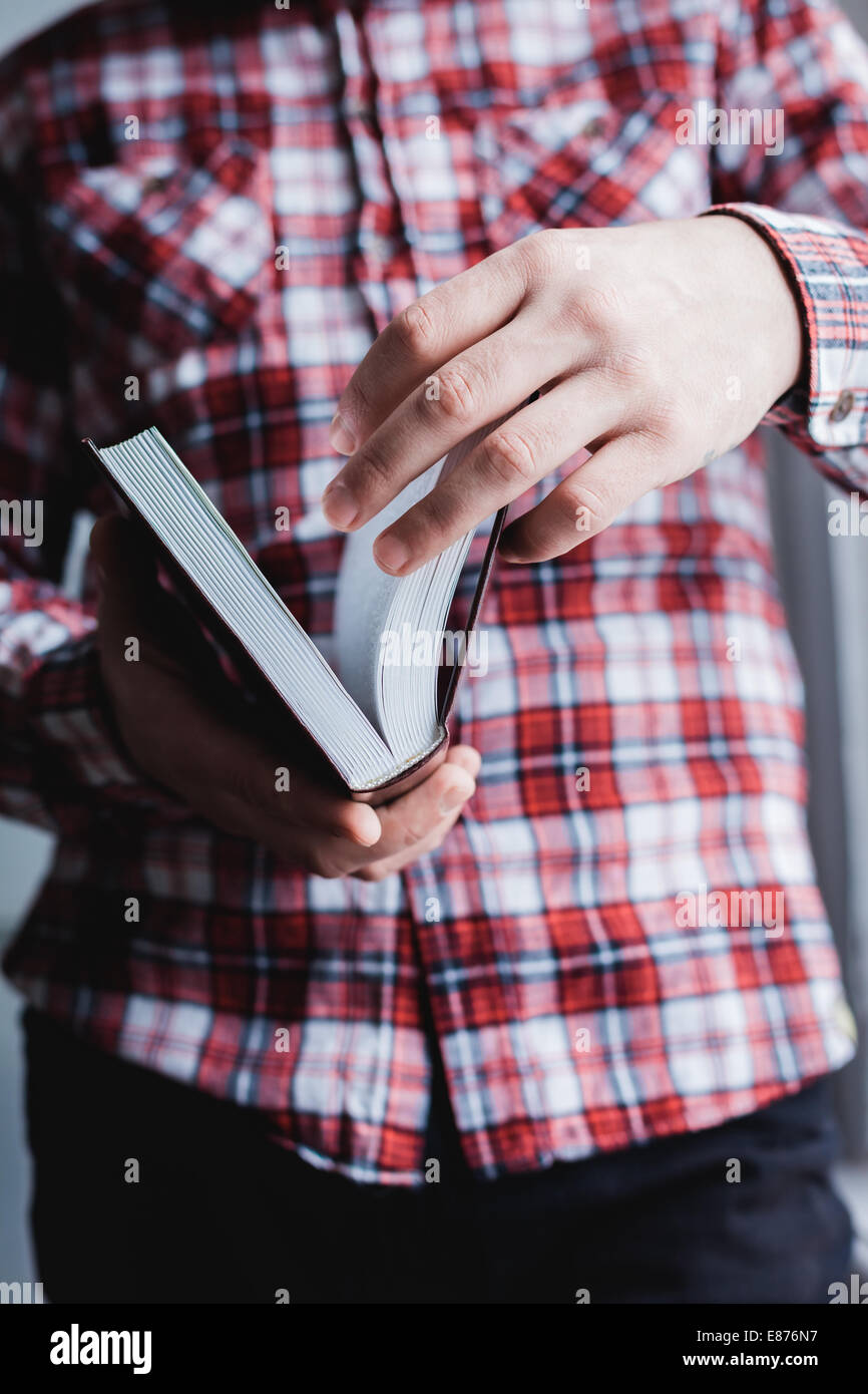 Man reading. Book in his hands Stock Photo - Alamy