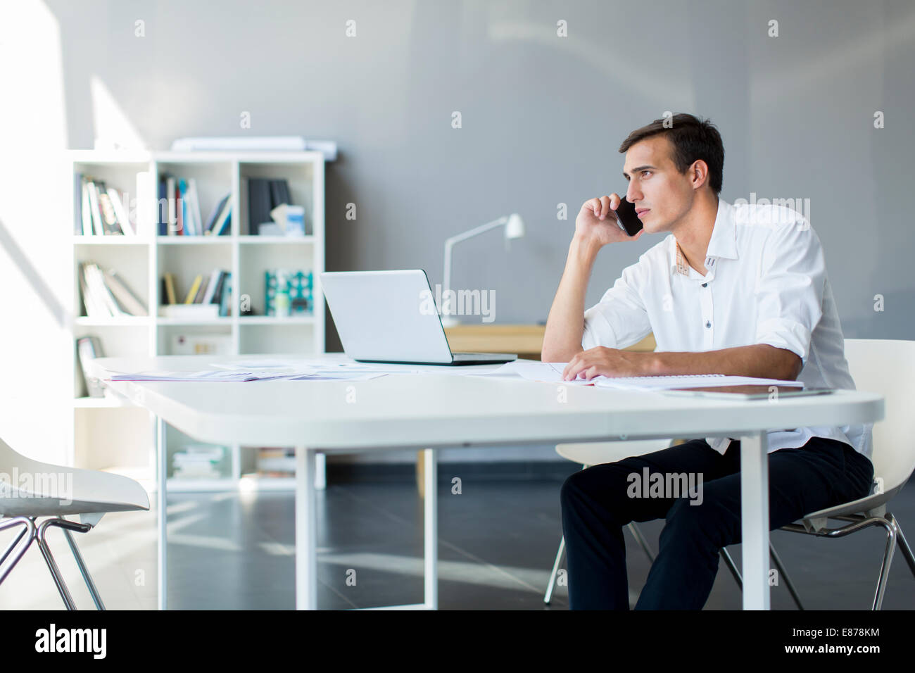 Young man in the office Stock Photo - Alamy