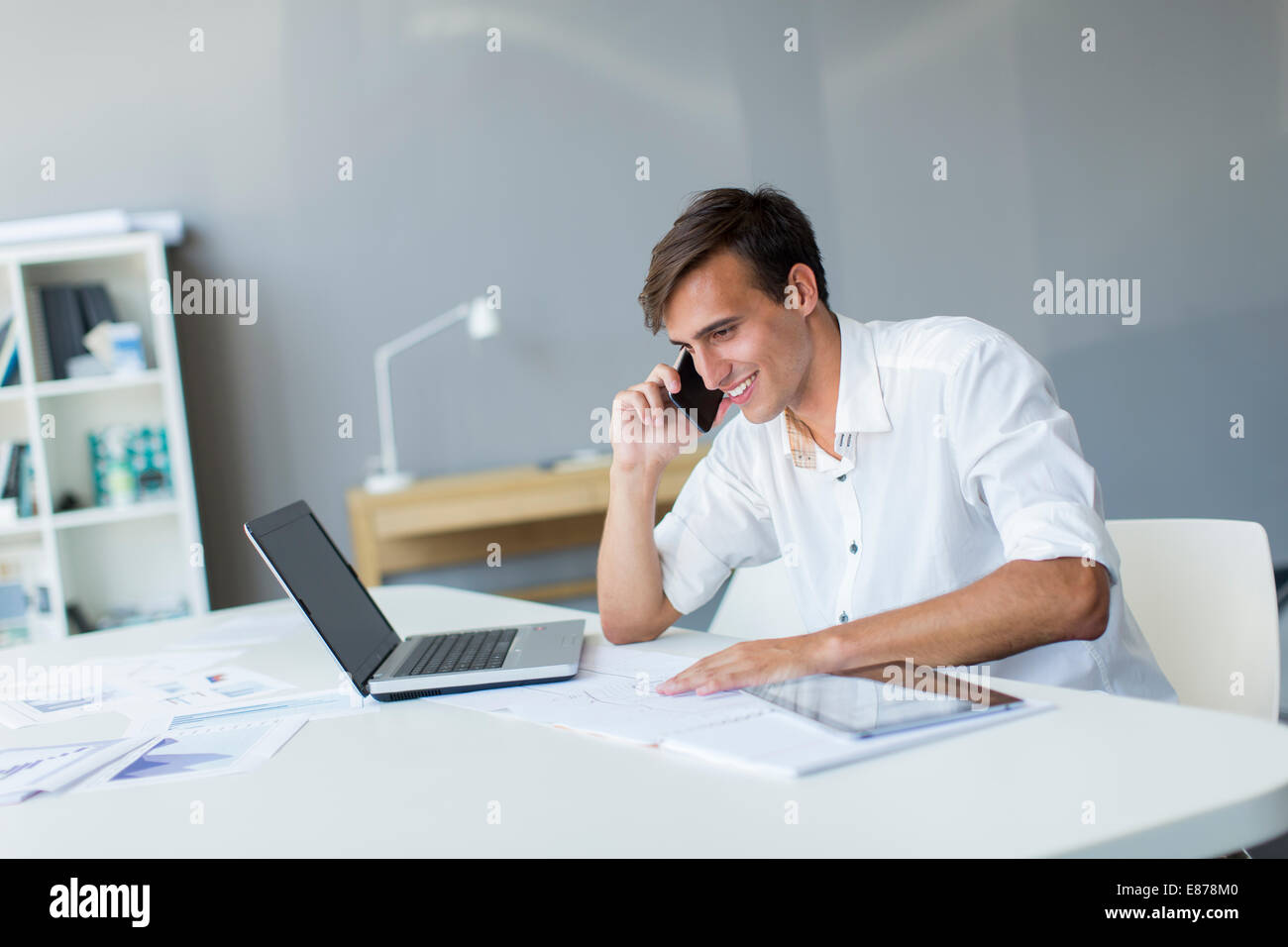 Young man in the office Stock Photo - Alamy