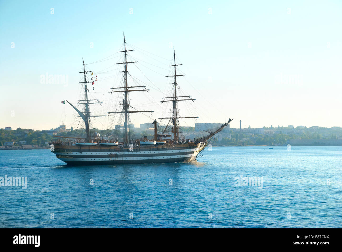 Beautiful sailing vessel in the sea comes into bay Stock Photo - Alamy