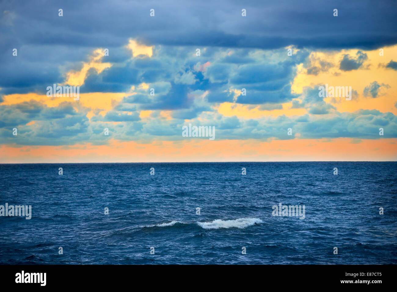 Big wave, colorful sunset over the sea with blue sky and clouds Stock ...