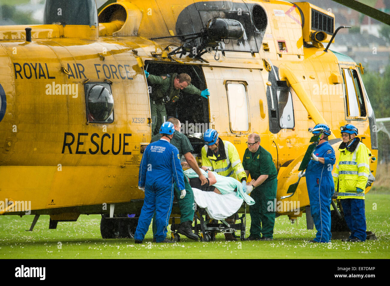 A RAF Air Sea rescue Sea King helicopter and crew transfering a man to ...
