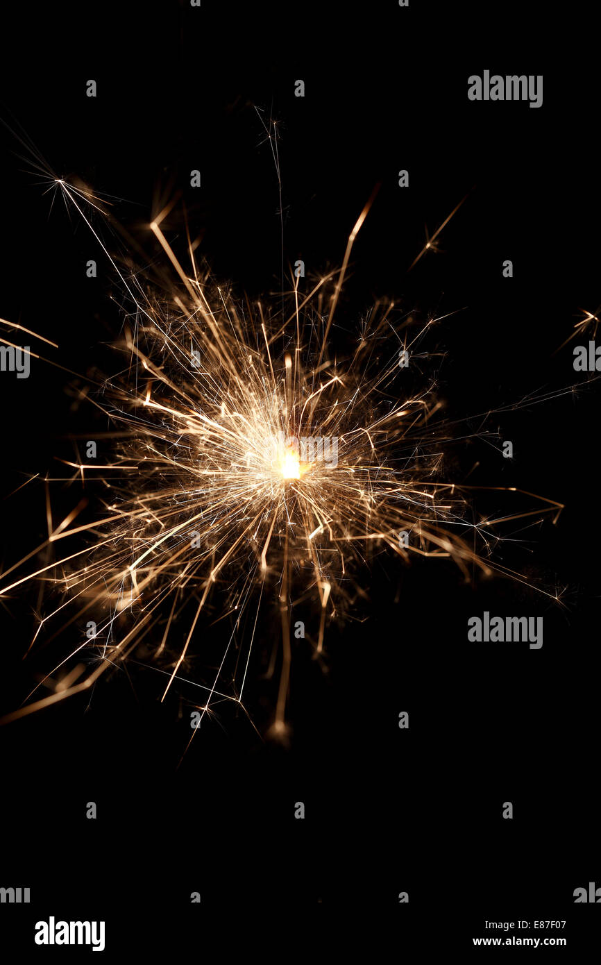 Burning sparkler in front of a black background Stock Photo - Alamy