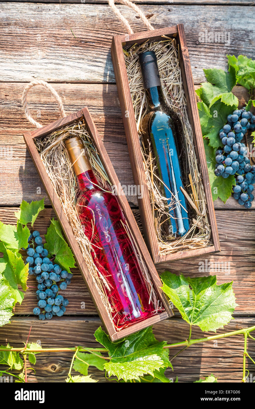 Different types of wine in a wooden box and grapes Stock Photo - Alamy
